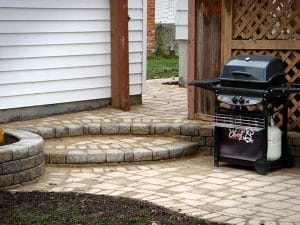 Patio and steps with Roman pavers and Roman Stack Stone retaining wall ...
