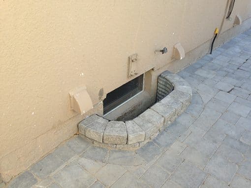 Retaining wall window well | The Lawn Salon